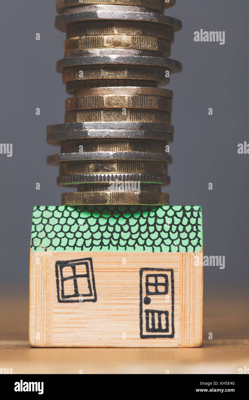 House model with coins. Home finance concept Stock Photo - Alamy