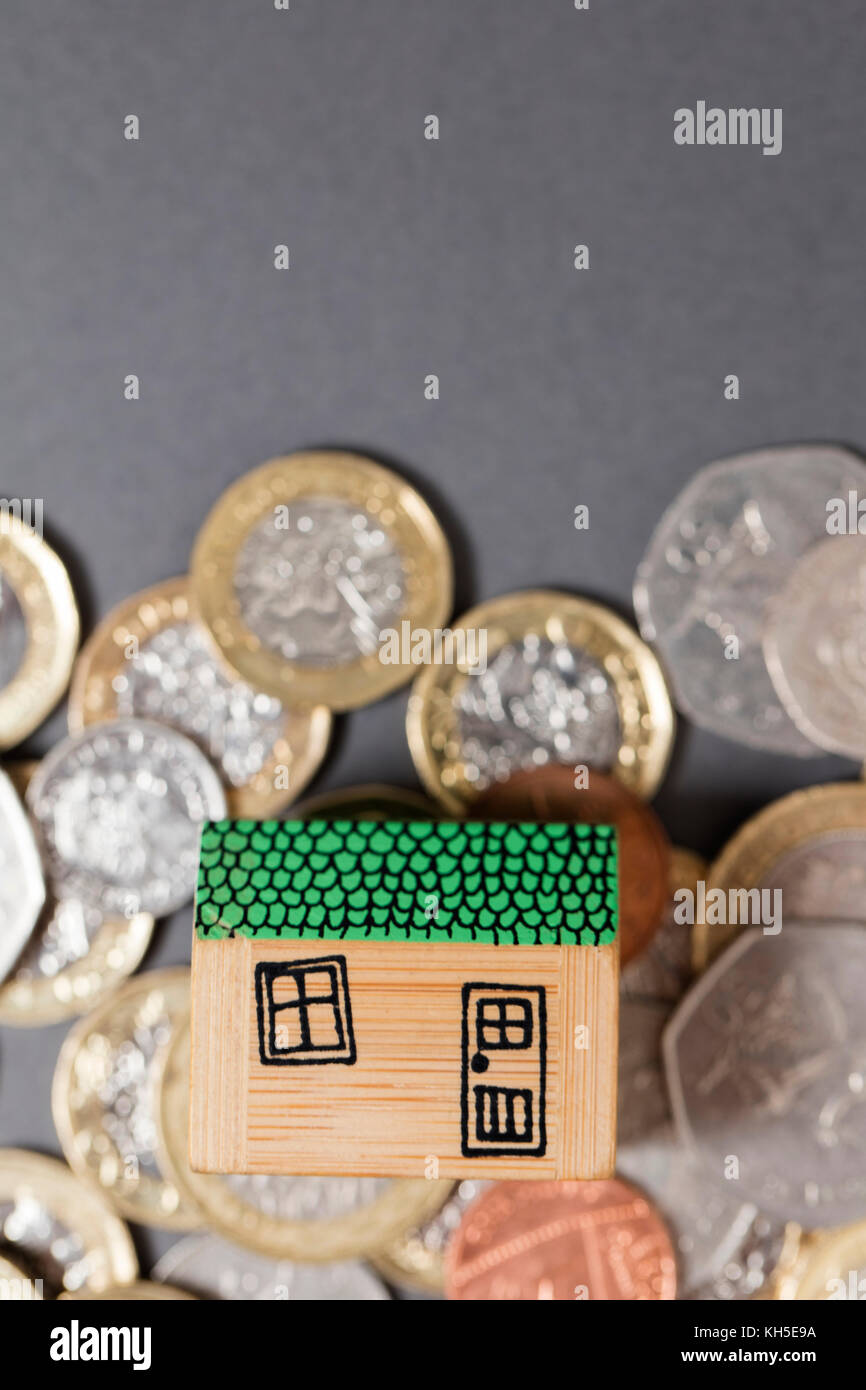 House model with coins. Home finance concept Stock Photo - Alamy