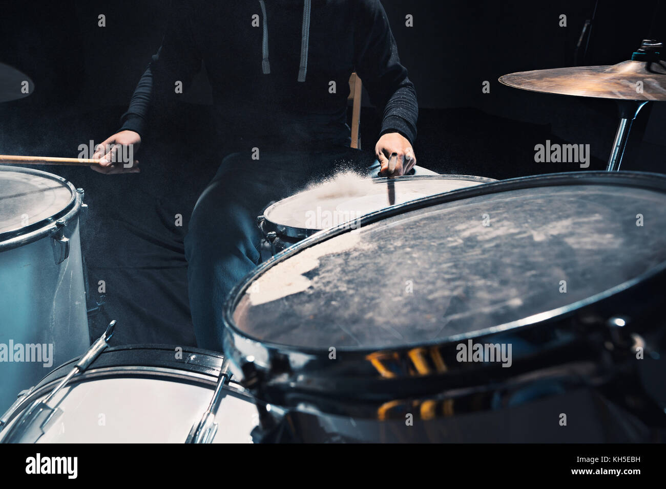 Drummer rehearsing on drums before rock concert. Man recording music on ...