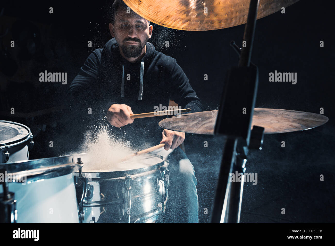 Drummer rehearsing on drums before rock concert. Man recording music on ...