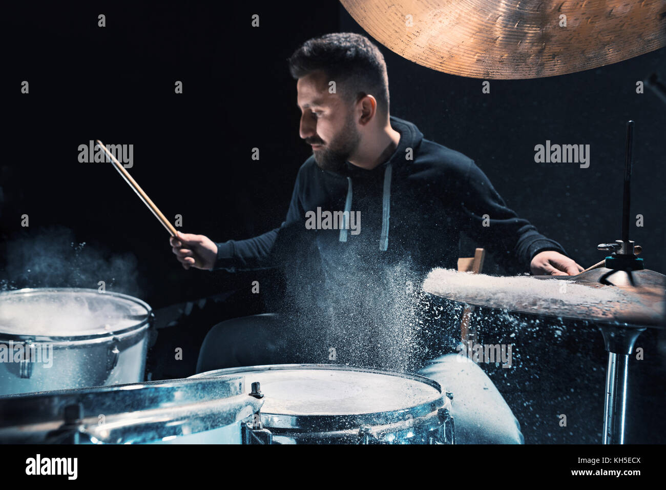 Drummer rehearsing on drums before rock concert. Man recording music on ...