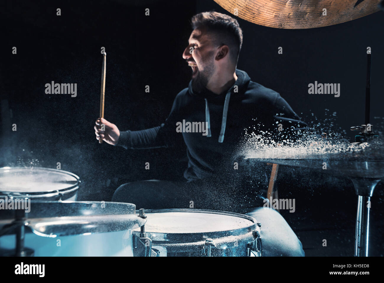 Drummer rehearsing on drums before rock concert. Man recording music on ...