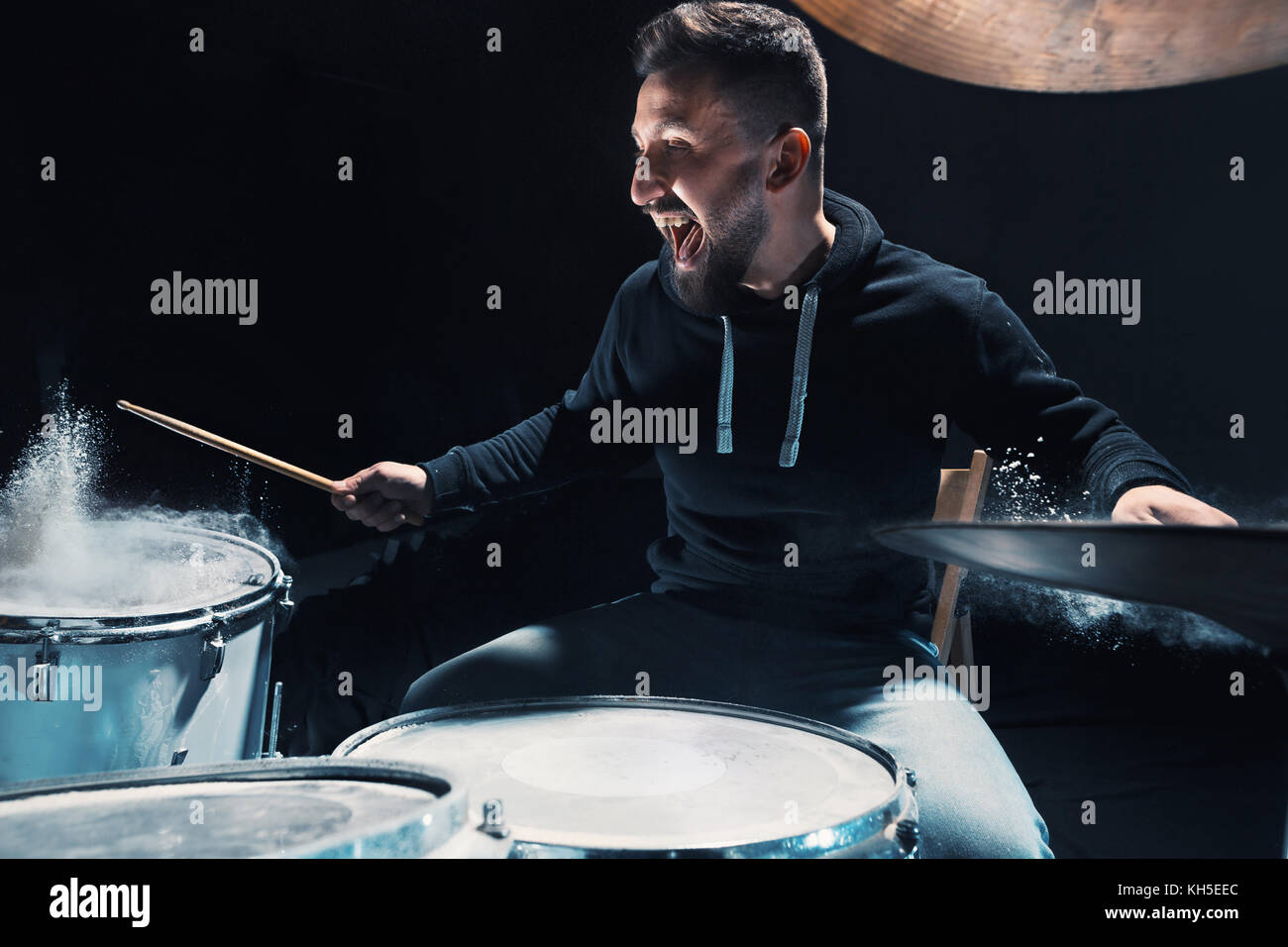 Drummer rehearsing on drums before rock concert. Man recording music on ...