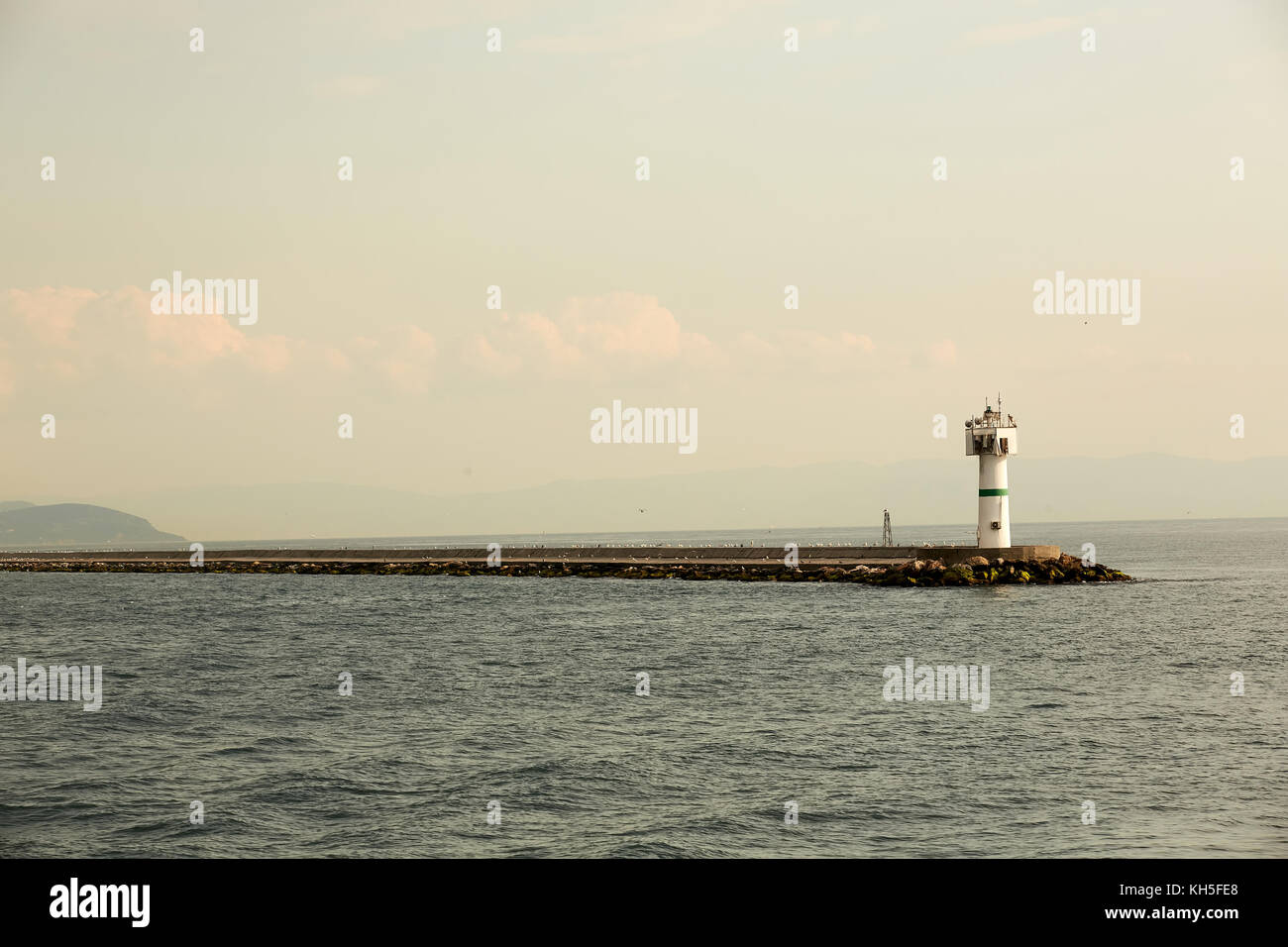 Beautiful seascape with lighthouse. Calm sea and a lighthouse on the ...