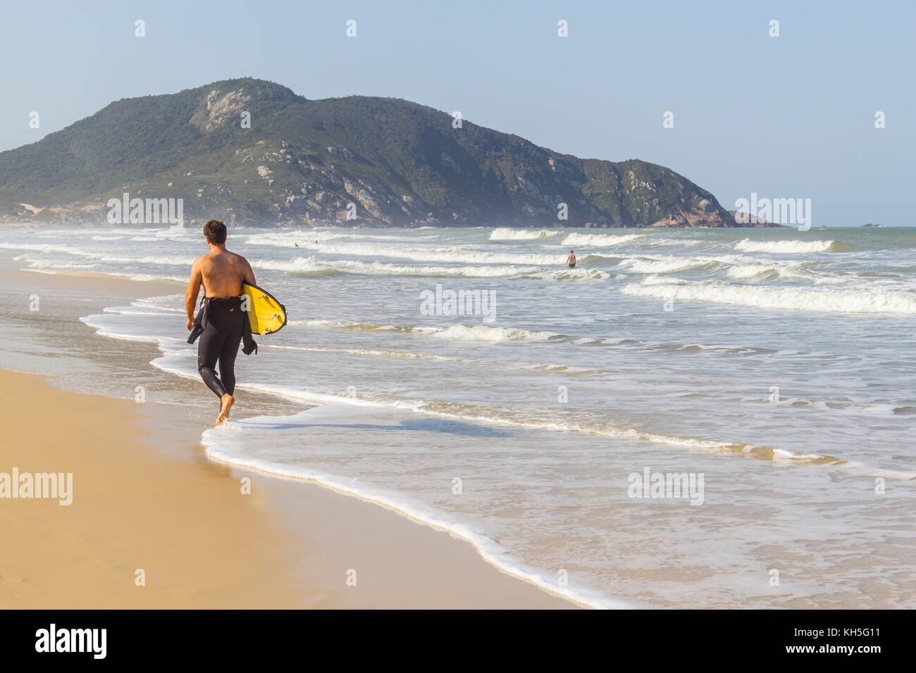 Surfer in Costao do Santinho beach, Florianopolis, Santa Catarina ...