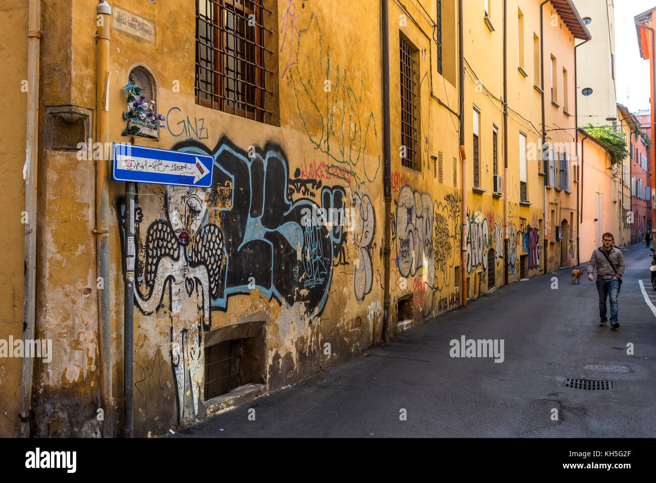 street sign, graffiti art and locals, Bologna city life, Italy Stock ...