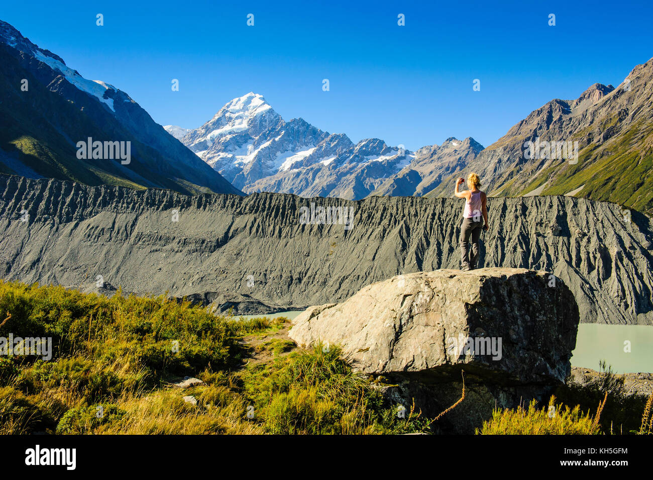 Woman photographing Mount Cook, South Island, New Zealand Stock Photo ...