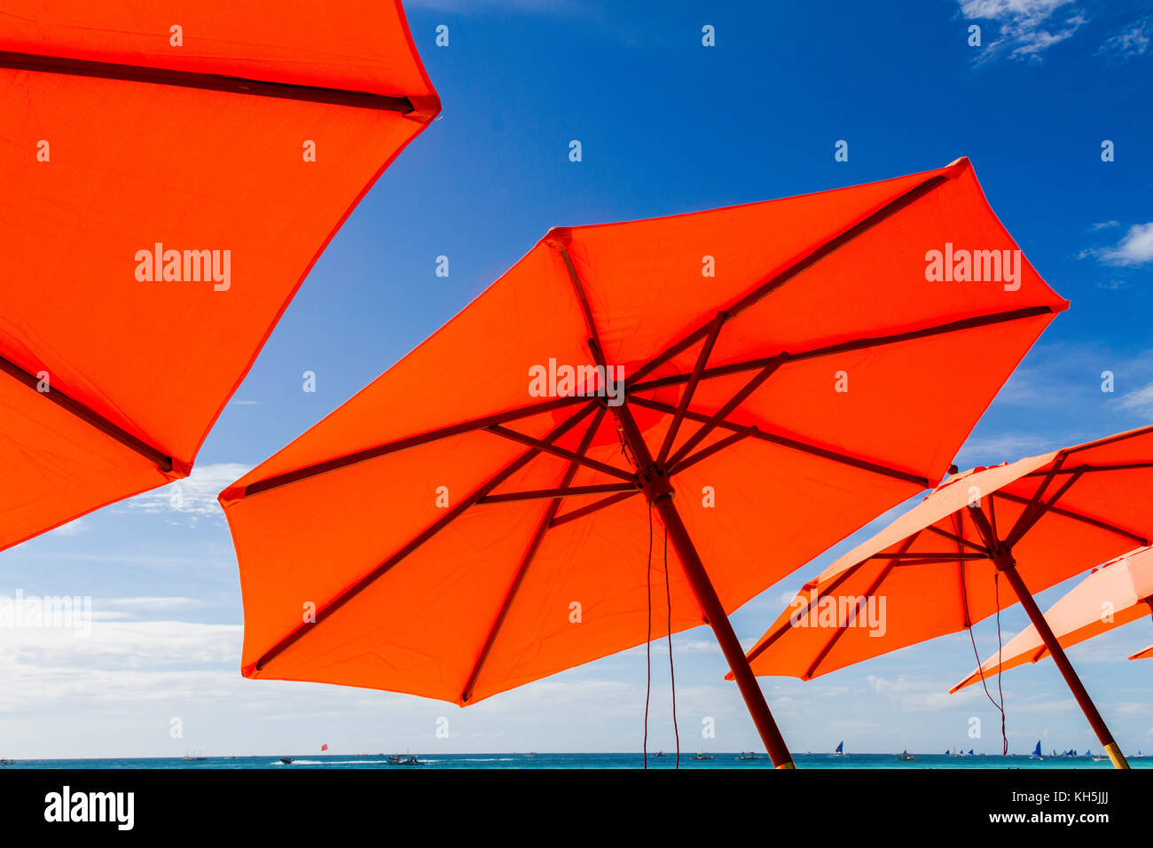 Colorful orange parasols on the beaches of Boracay, Visayas ...