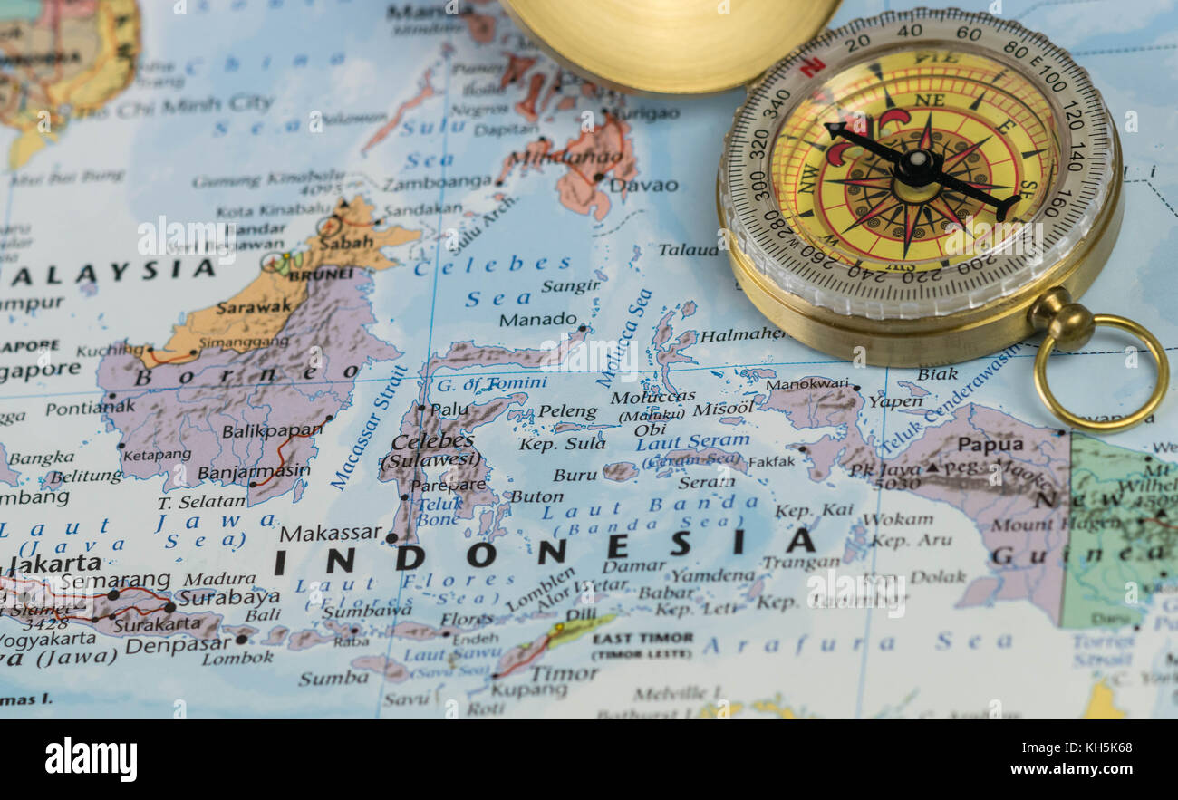 Compass on a close up map pointing at Indonesia and planning a travel ...