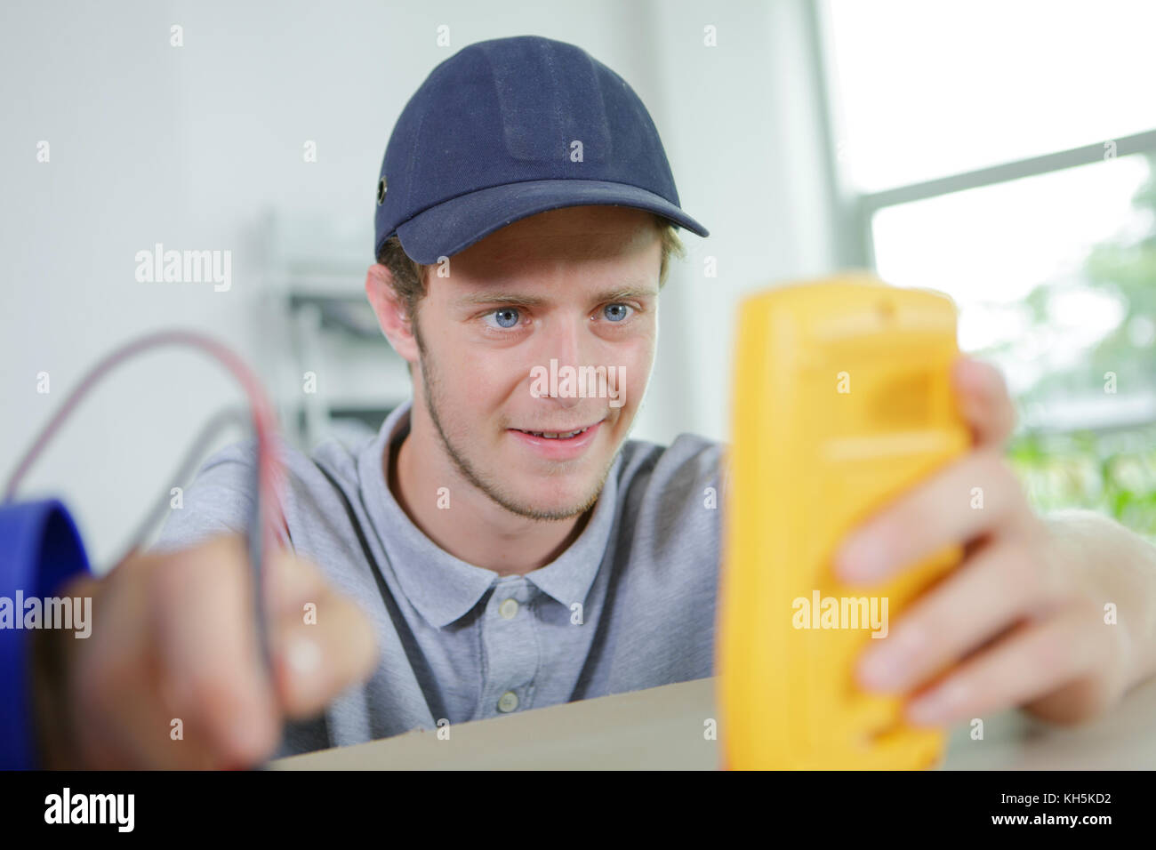 Man excitedly using multi meter Stock Photo - Alamy