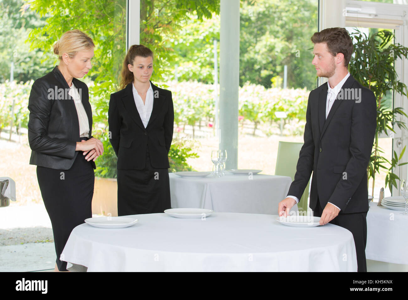 waitress and waiter at catering service in restaurant Stock Photo - Alamy