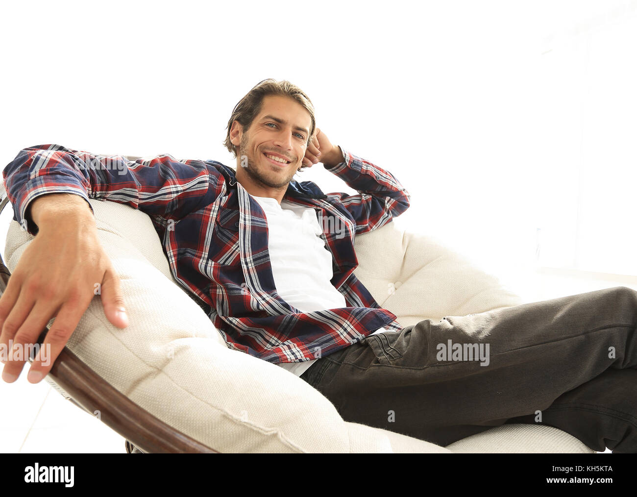 serious guy rests sitting in a large comfortable chair. side view Stock ...