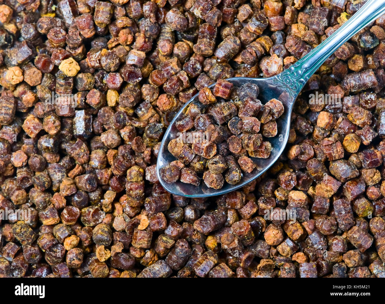 Propolis granules background with spoon inside, bee product Stock Photo ...