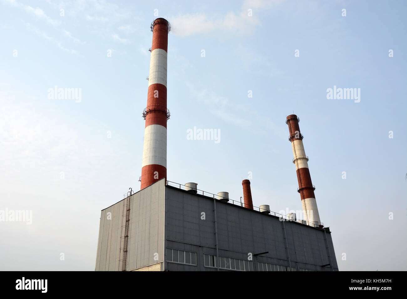 Factory building with smokestacks and blue sky background Stock Photo ...
