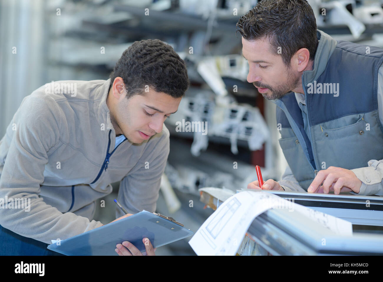 engineer taking notes from manager at control room Stock Photo - Alamy