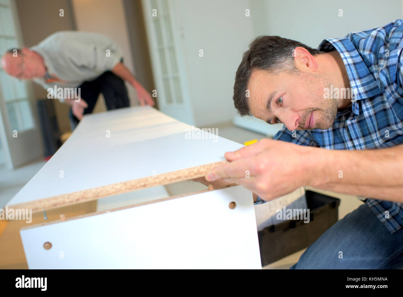Putting together flap pack furniture Stock Photo - Alamy