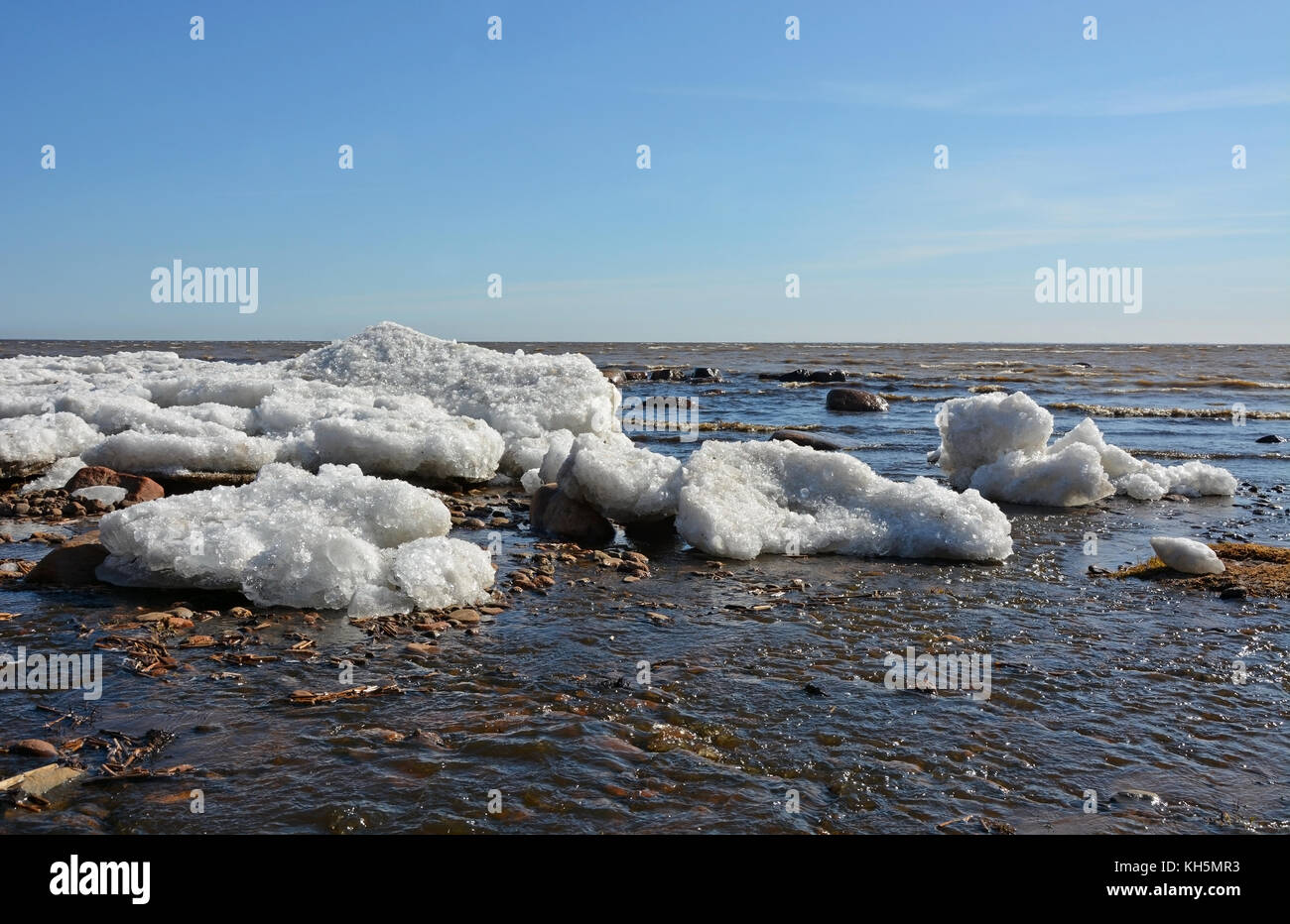 Coastal line with ice and sea. Spring season Stock Photo - Alamy