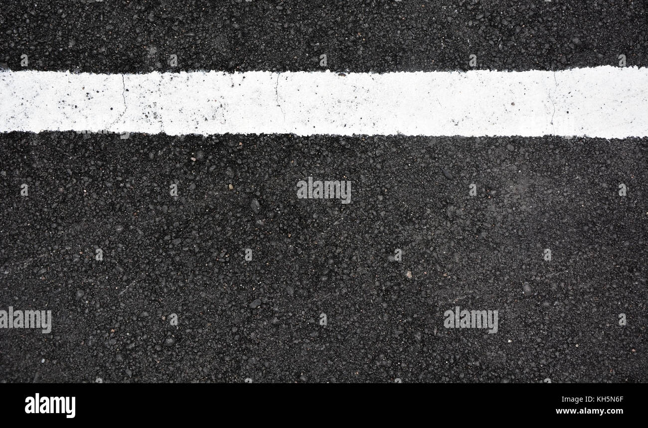 Strip of white paint on the asphalt road Stock Photo - Alamy