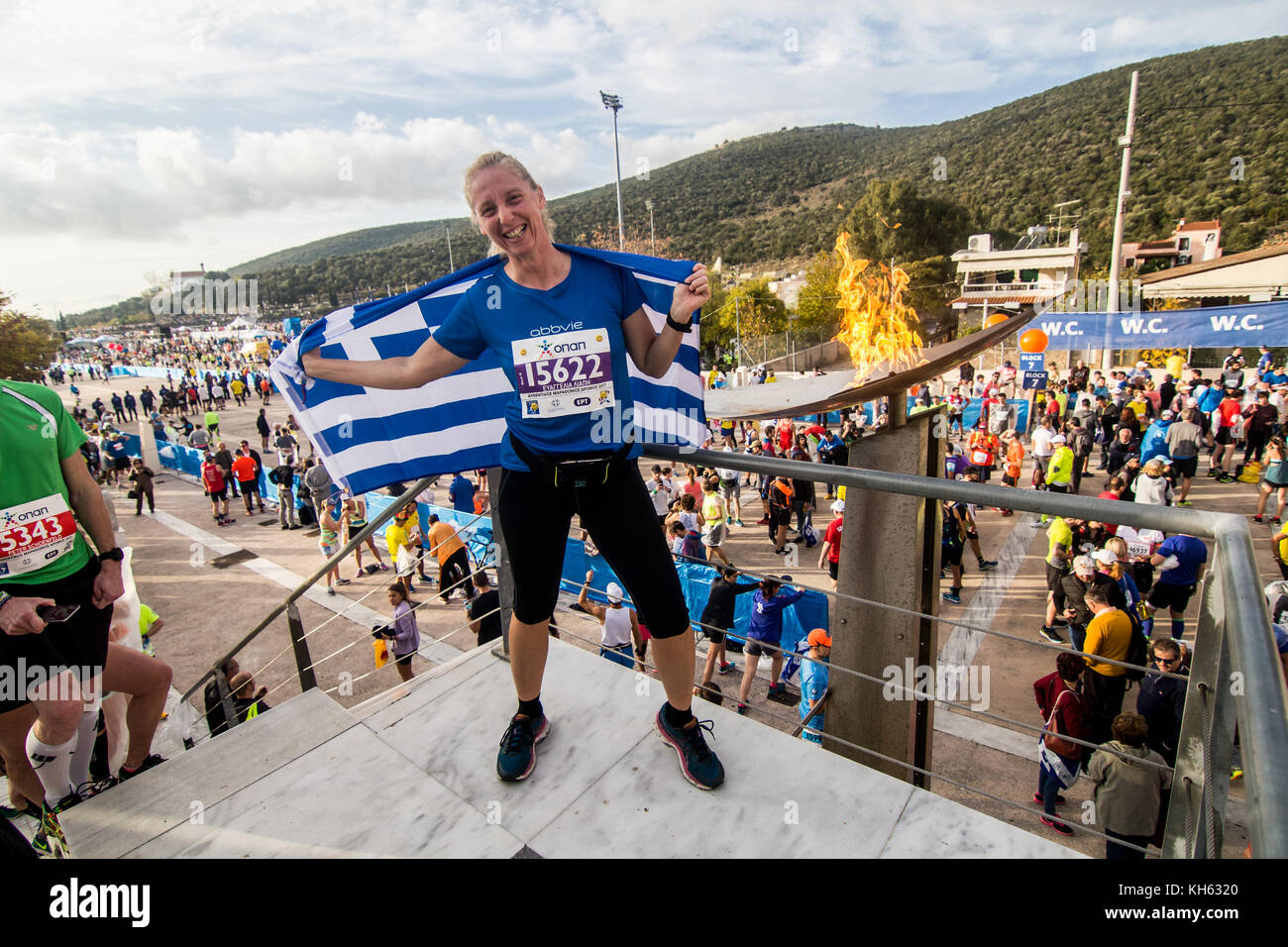 A Greek woman poses next to the flame at Marathonas stadium before the ...