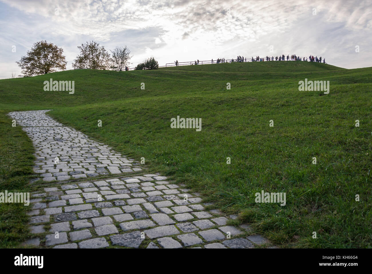 A cobblestone road upt to the Olympiaberg in Olympiapark in Munich ...