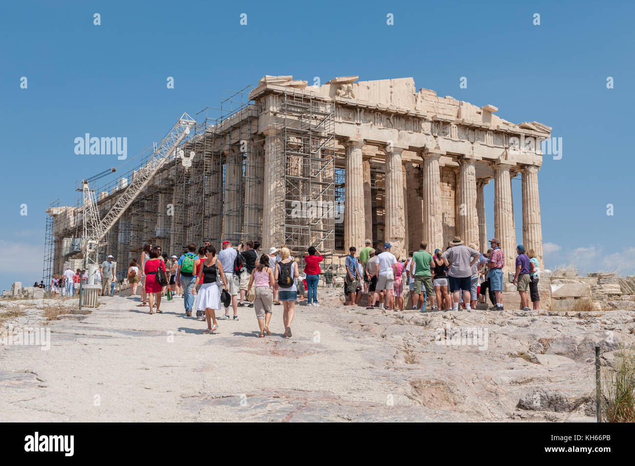 Tourists admire the Parthenon at Acropolis of Athens. This temple was ...