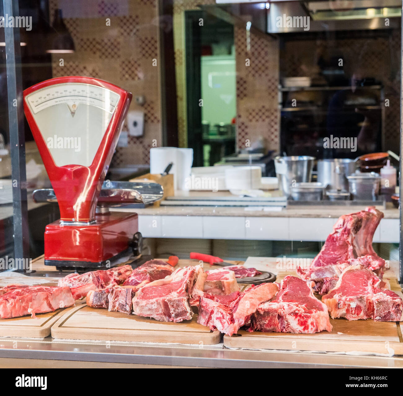 Raw red meat on a cutting board next to scales Stock Photo - Alamy