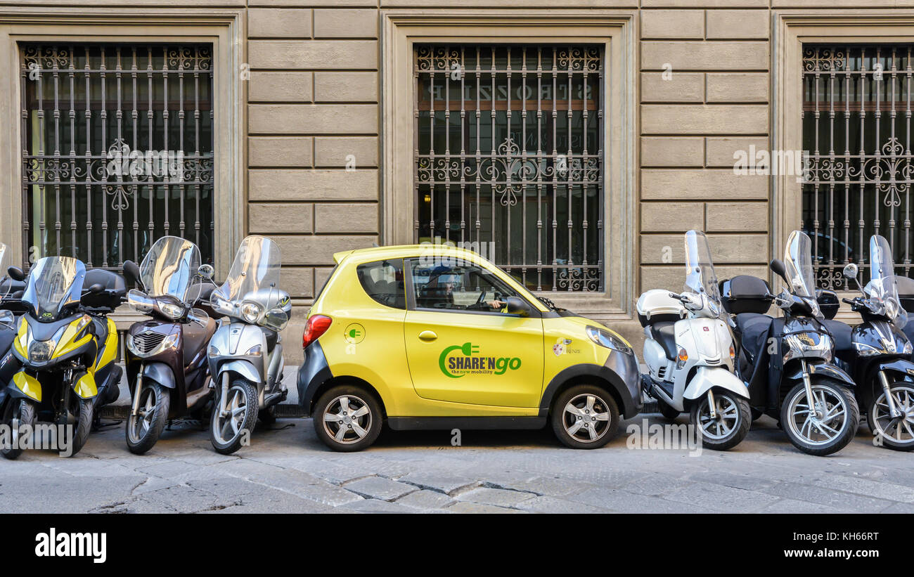 Electric crowd sharing Share 'n Go vehicle charging on dock in street ...