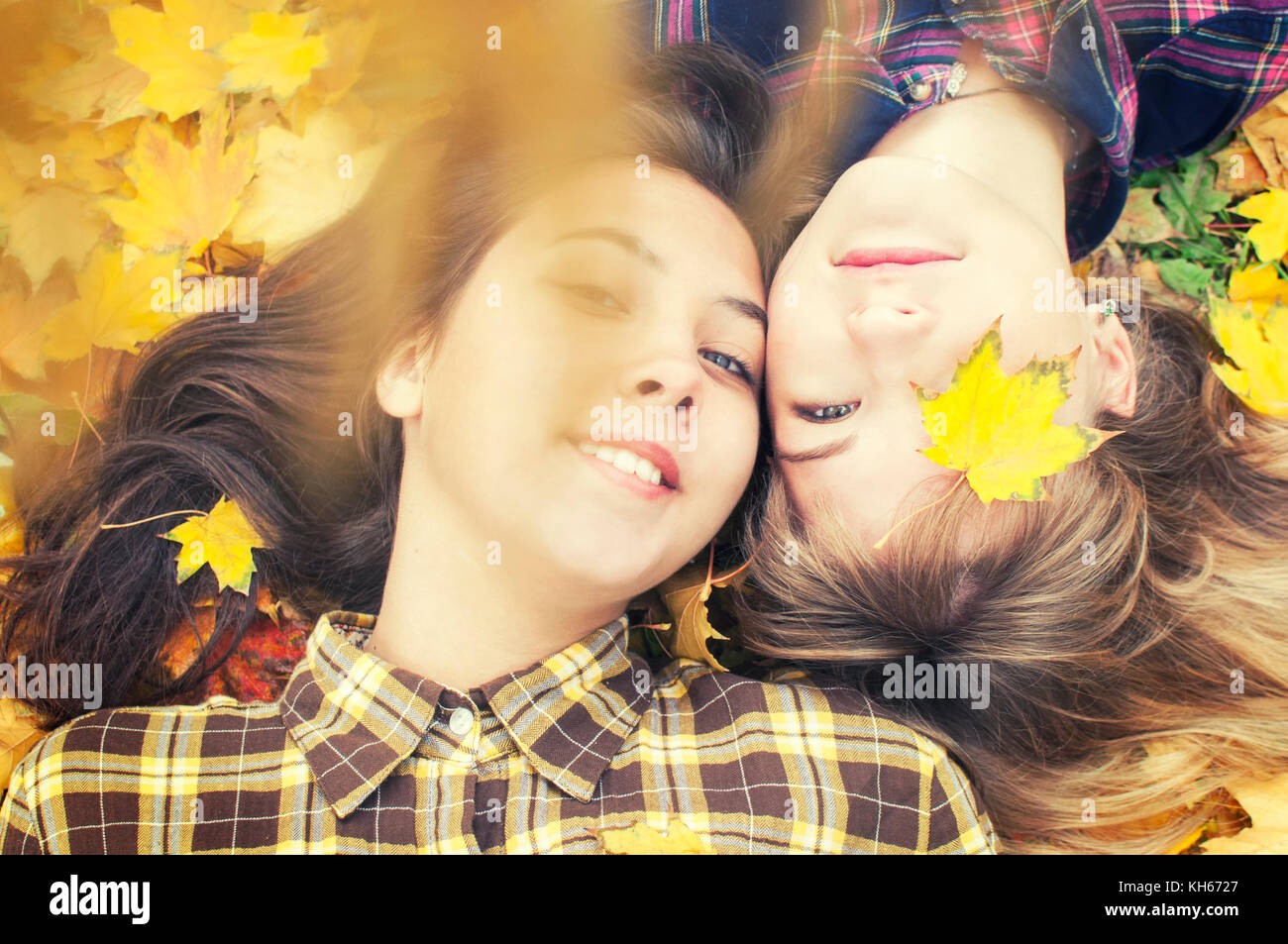 Two young girls on a walk in the autumn park Stock Photo - Alamy