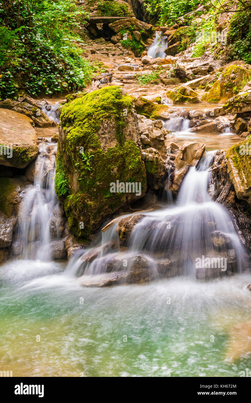 Waterfall and small lake in the ravine Chudo-Krasotka in summer day ...