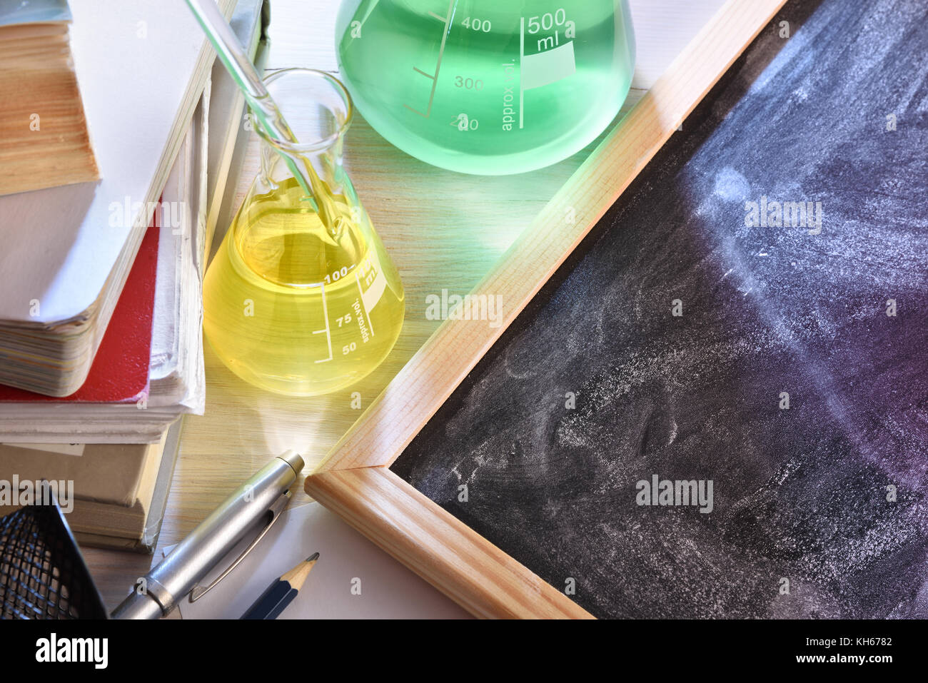 Classroom desk and blackboard of chemistry teaching with books and ...