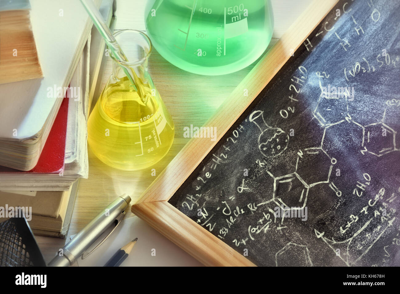 Classroom desk and drawn blackboard of chemistry teaching with books ...