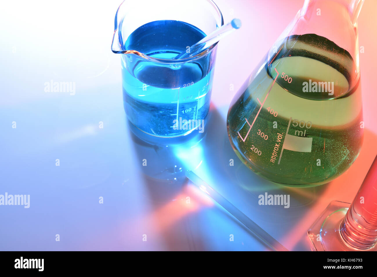 Laboratory glass chemical containers on glass table isolated colorful ...