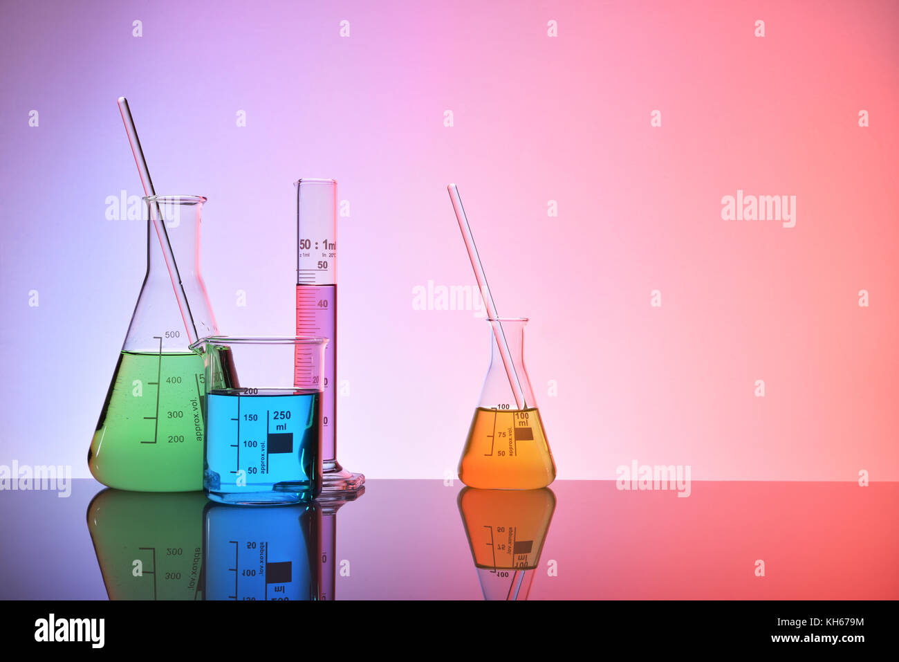 Laboratory glass chemical containers on glass table isolated colorful ...