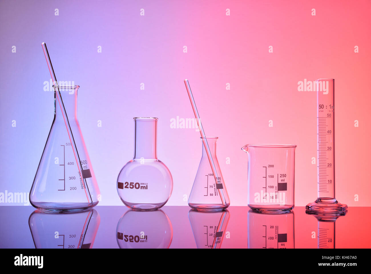 Supply of empty laboratory glass chemical containers on glass table ...