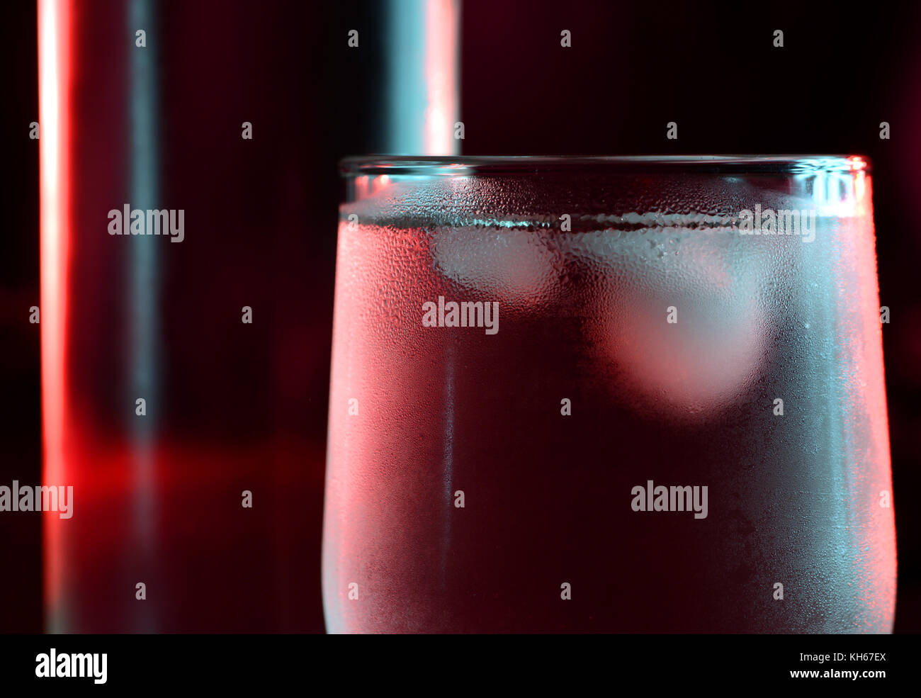 two frosted glasses with cold drinks on red background Stock Photo - Alamy