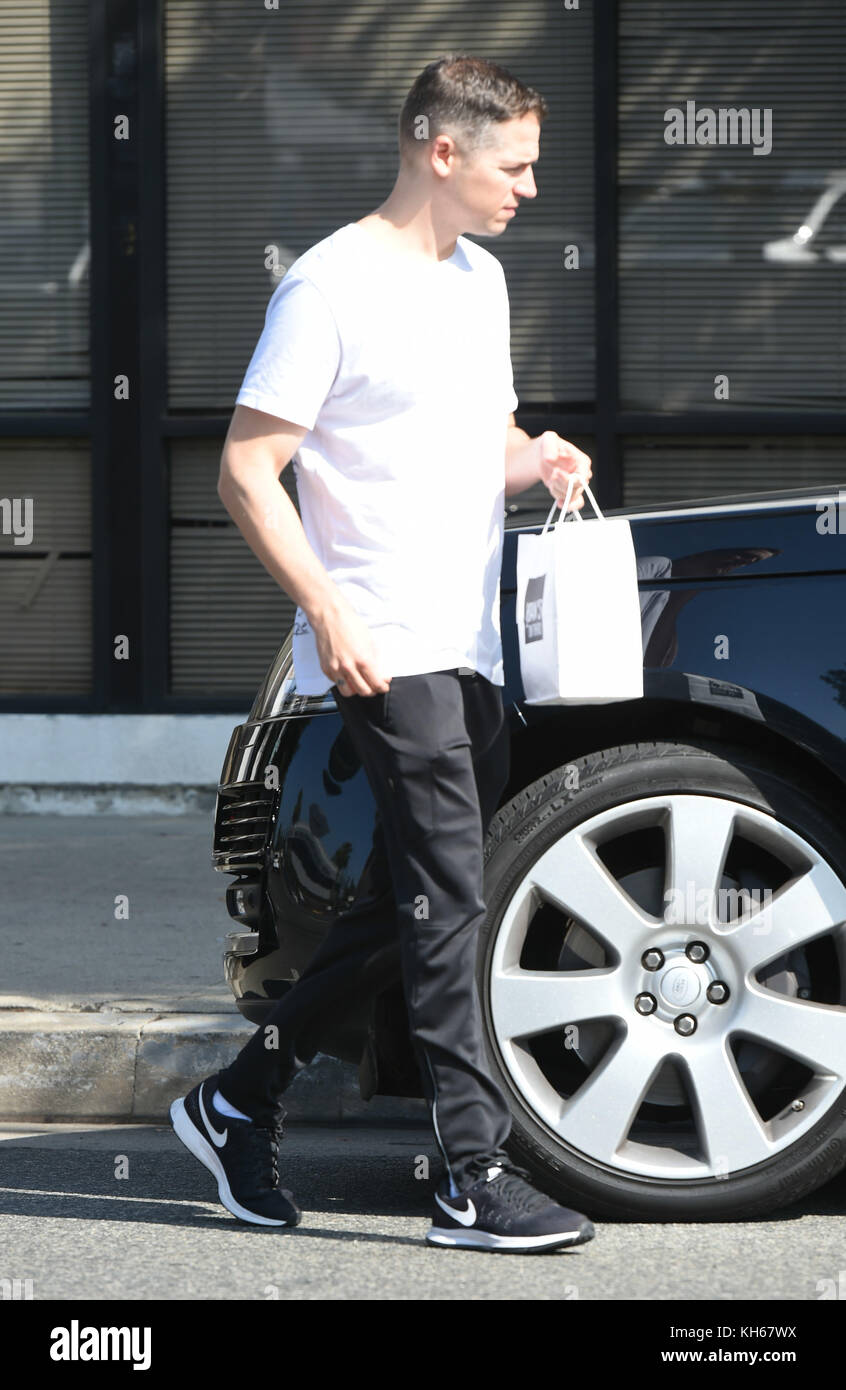 Jason Kennedy returns to his car carrying lunch Featuring: Jason ...