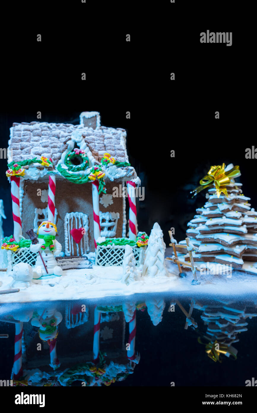 Big snow-covered homemade gingerbread house, gingerbread Christmas tree ...
