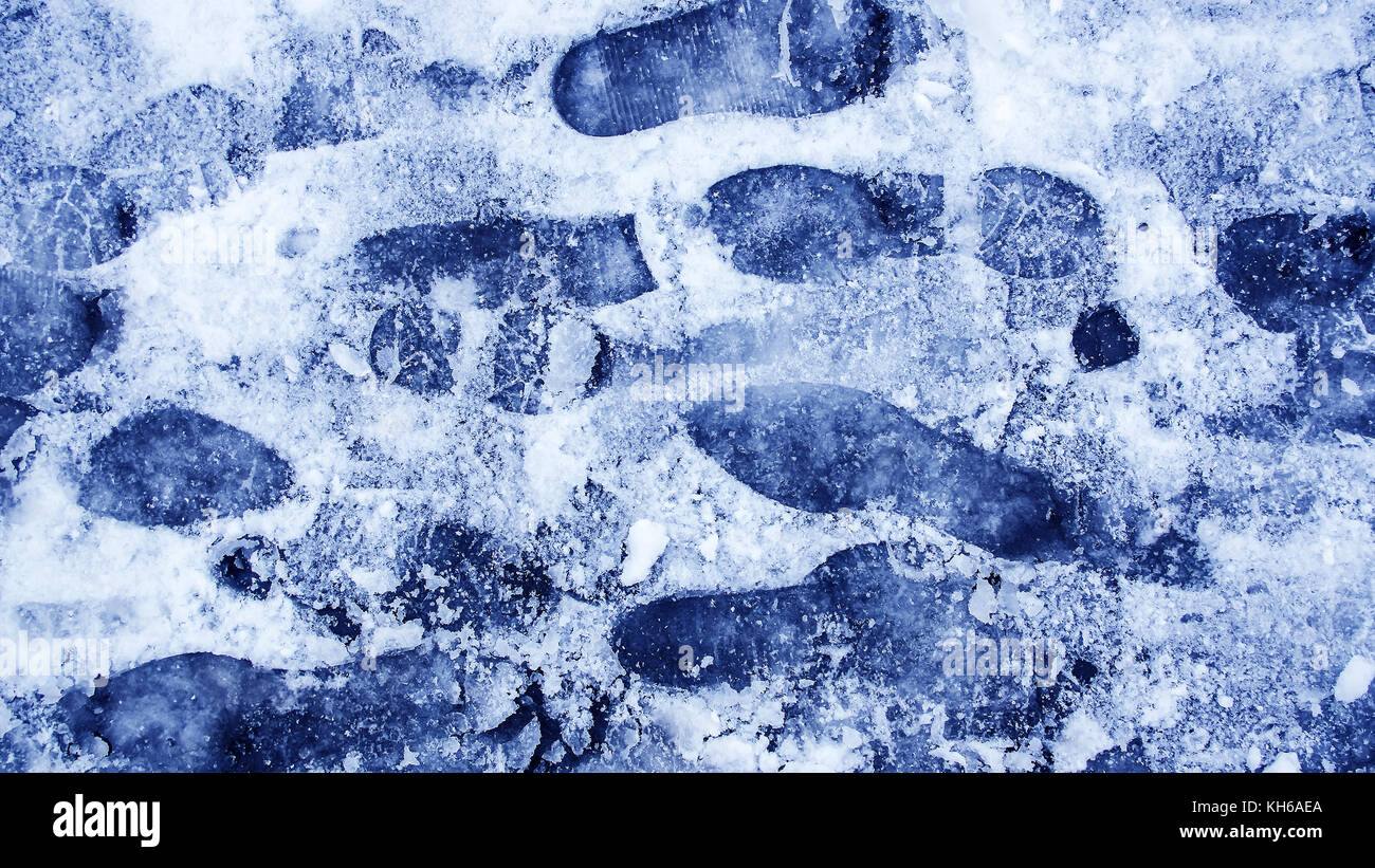 Dirty footprints in the snow winter. Track from boots on the tra Stock ...