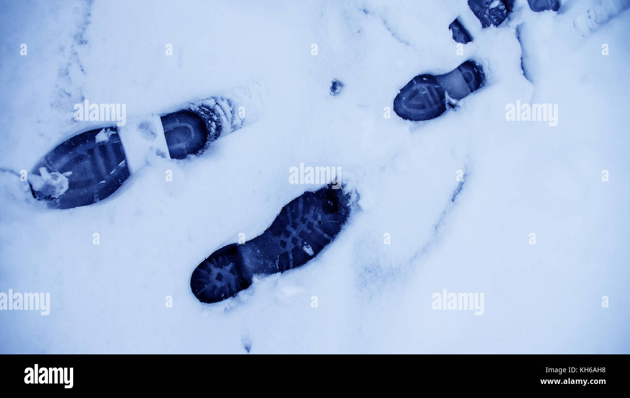 Dirty footprints in the snow winter. Track from boots on the tra Stock ...