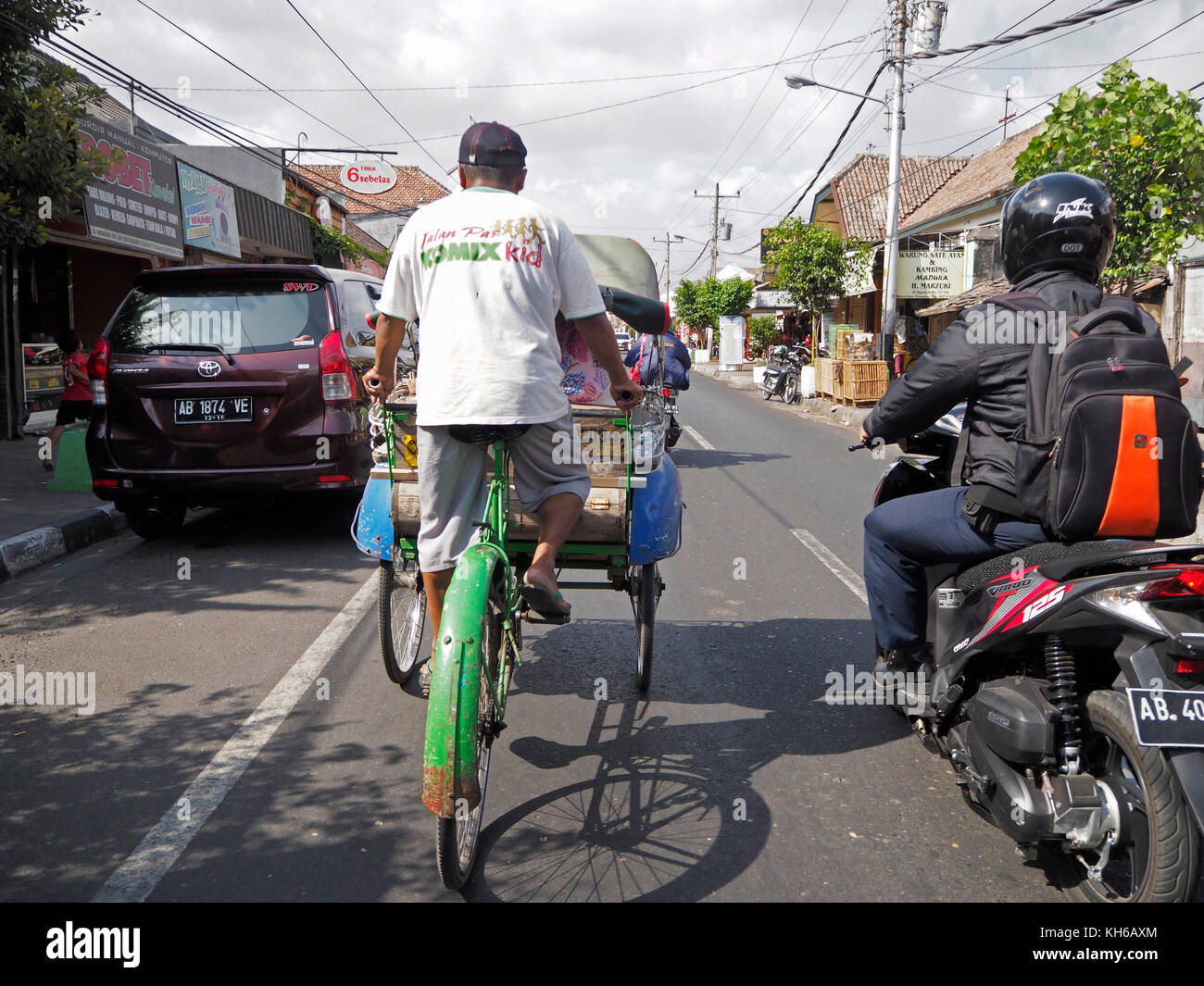 Pedicab and motorcycle on the street of Jogjakarta, Central Java ...