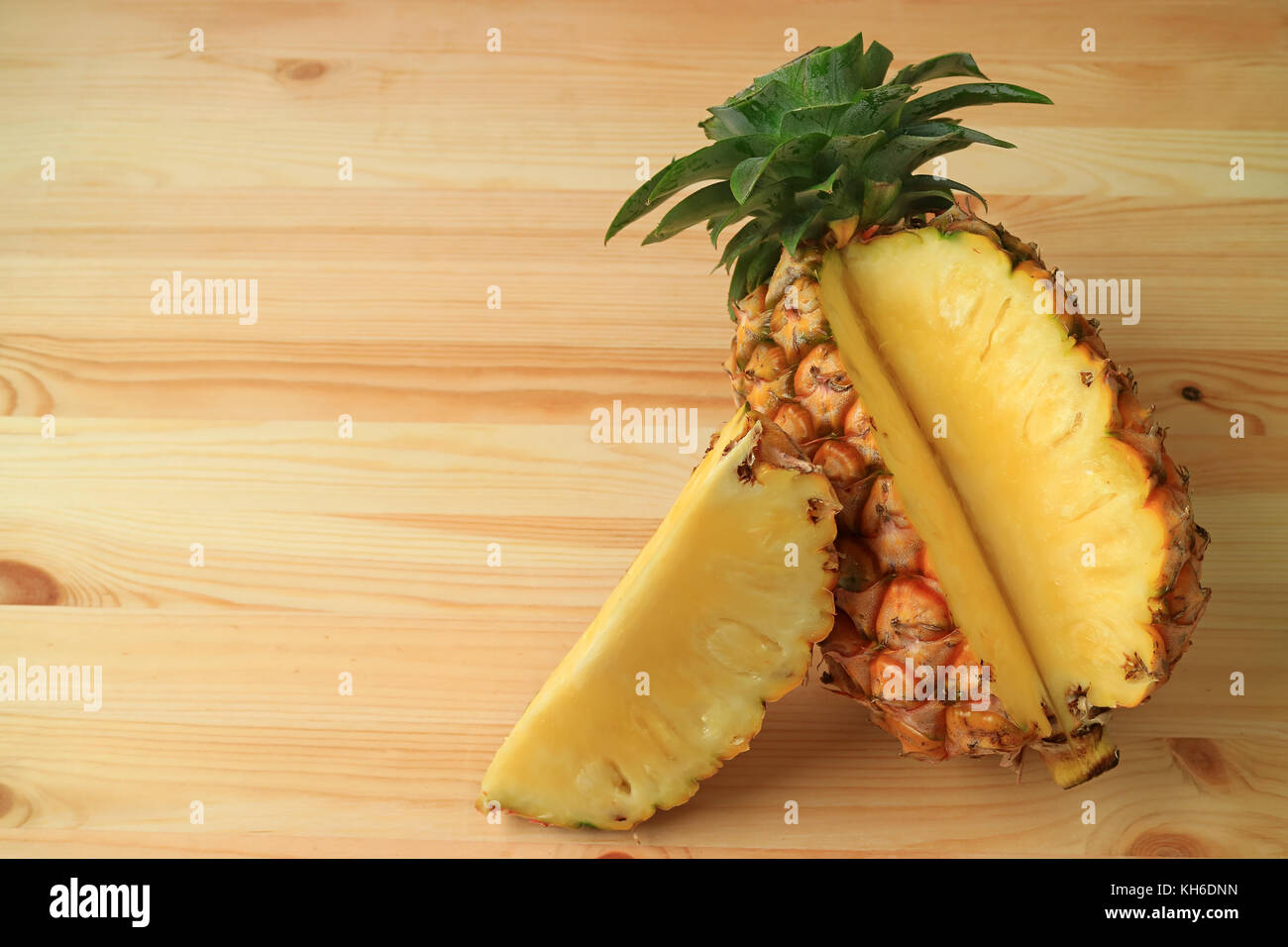 Piece of fresh ripe pineapple cut from the whole fruit isolated on ...
