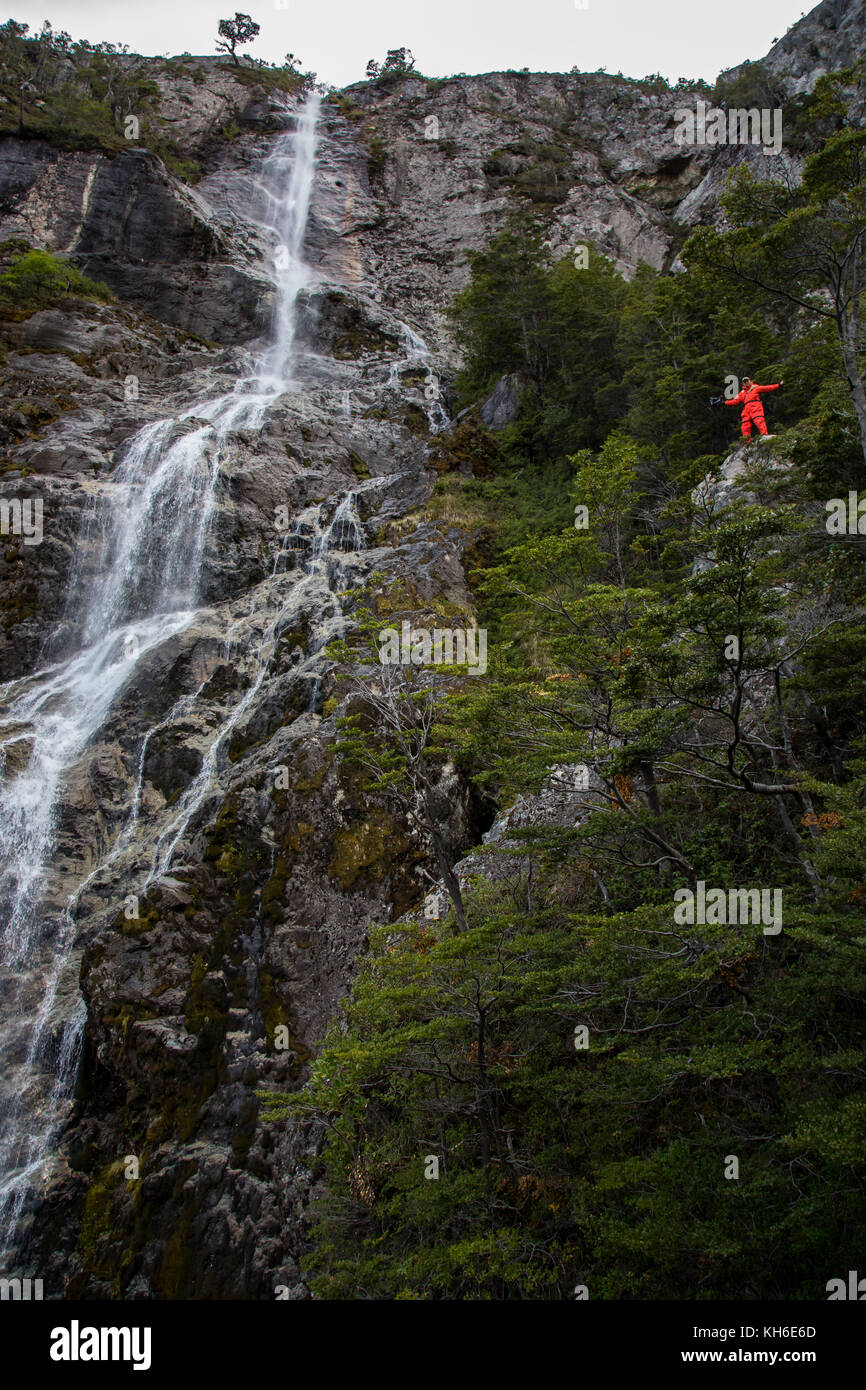 A hiker provides scale at a large waterfall in Karukinka reserve in ...