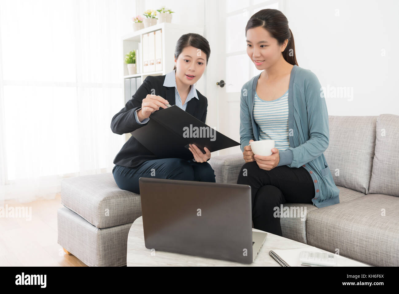 professional young insurance agent woman going to customer's home ...