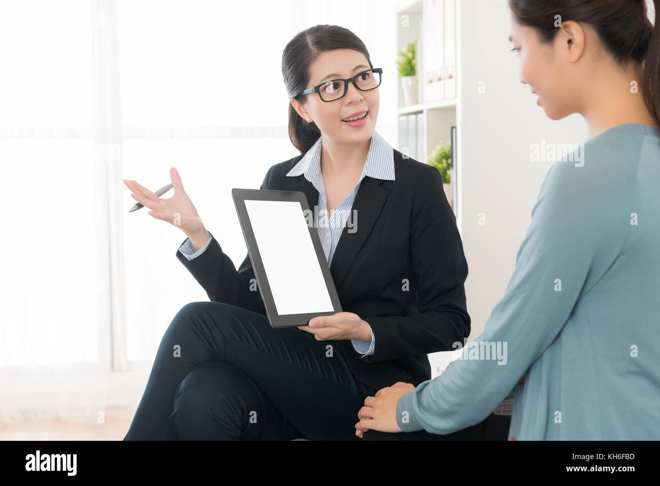 professional smiling insurance agent looking at her client talking ...