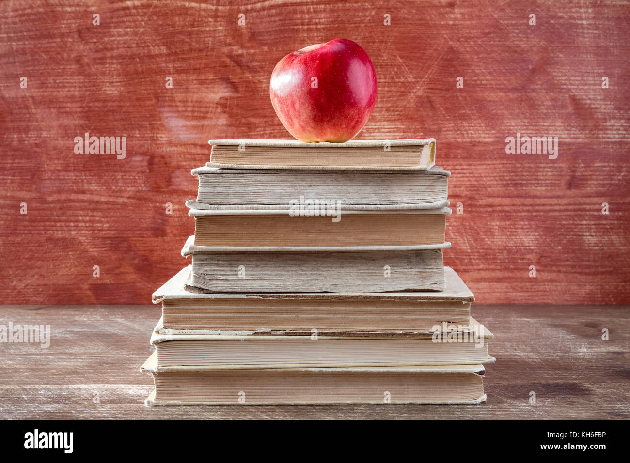 Books pyramid with red apple. Education concept Stock Photo - Alamy