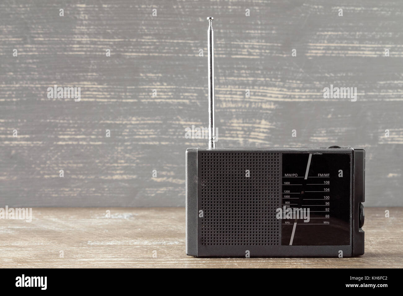 Old portable radio receiver device on wooden background Stock Photo - Alamy