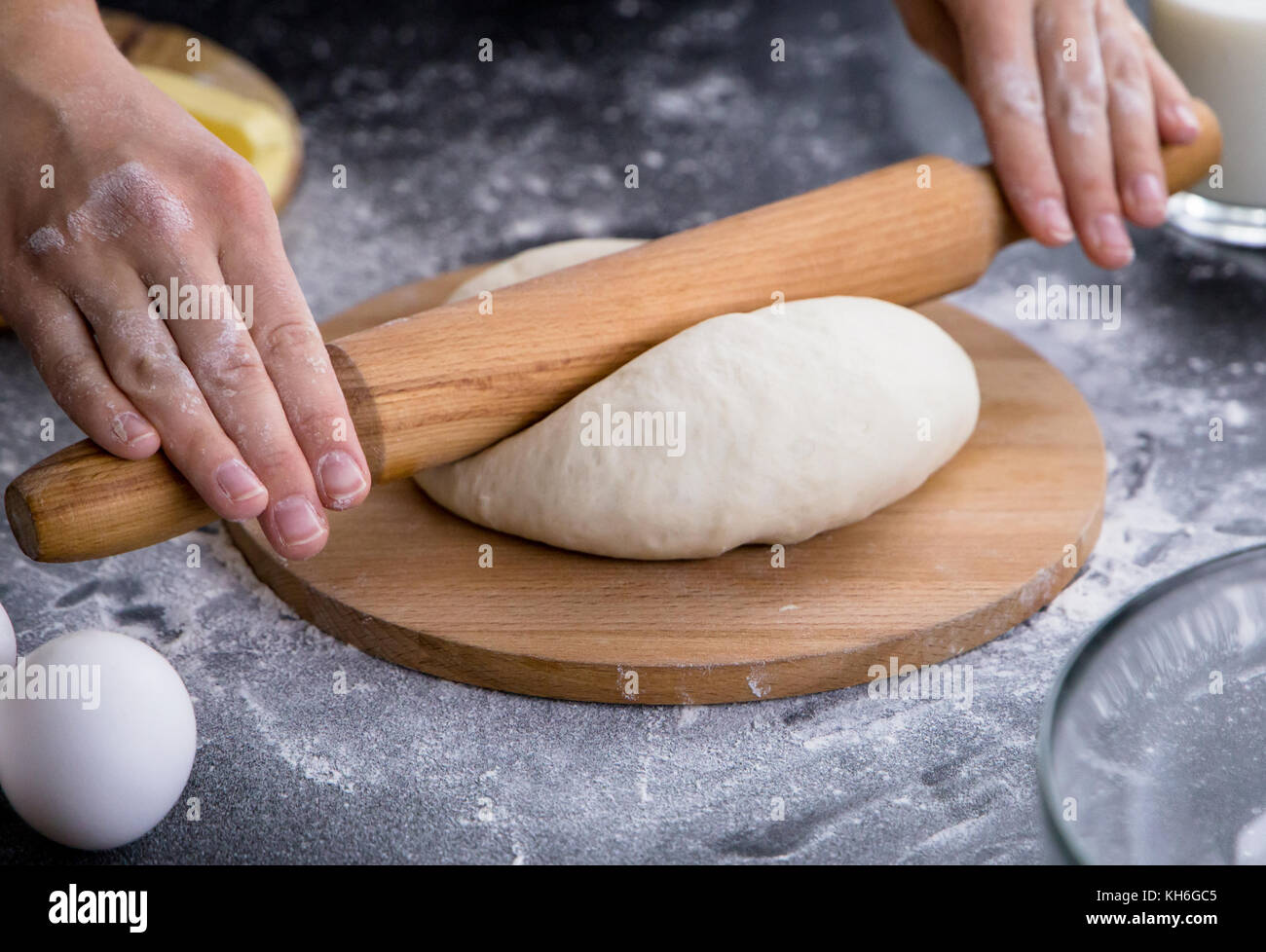 Making dough by female hands on wooden table background Stock Photo - Alamy