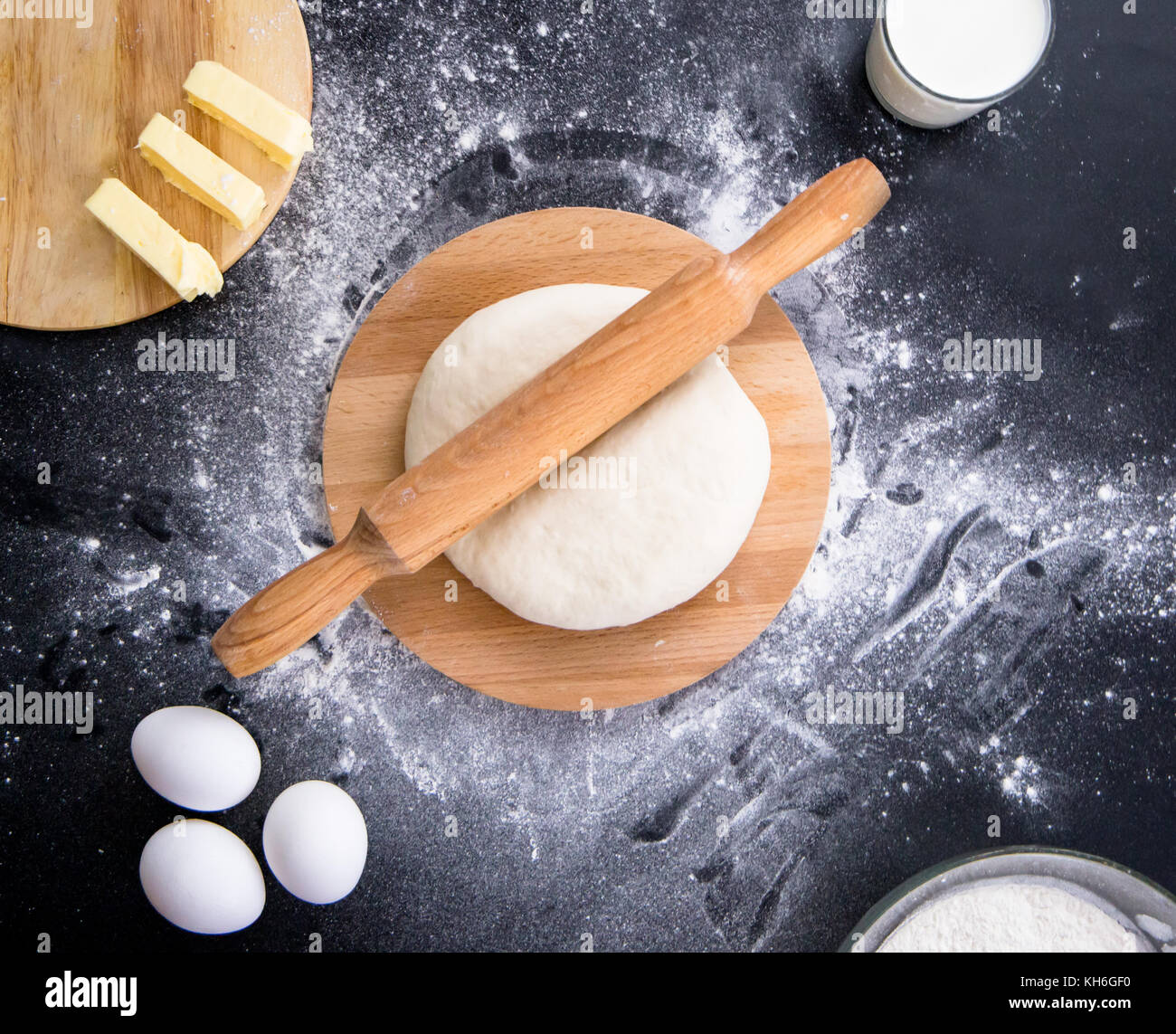 Making dough by female hands on wooden table background Stock Photo - Alamy