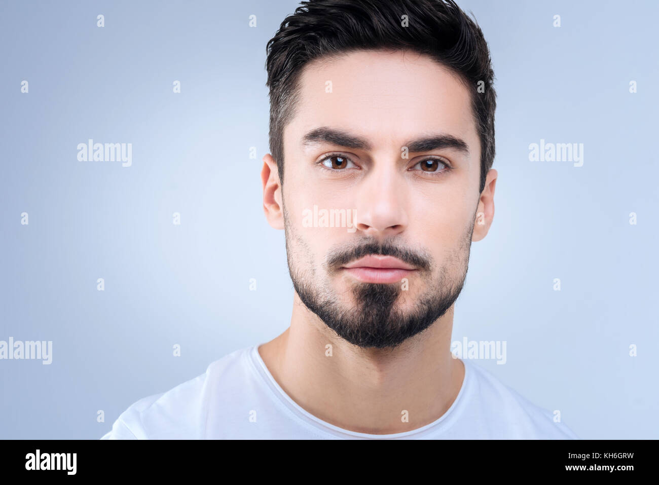 Sensitive portrait of a handsome man looking calm and self assured ...