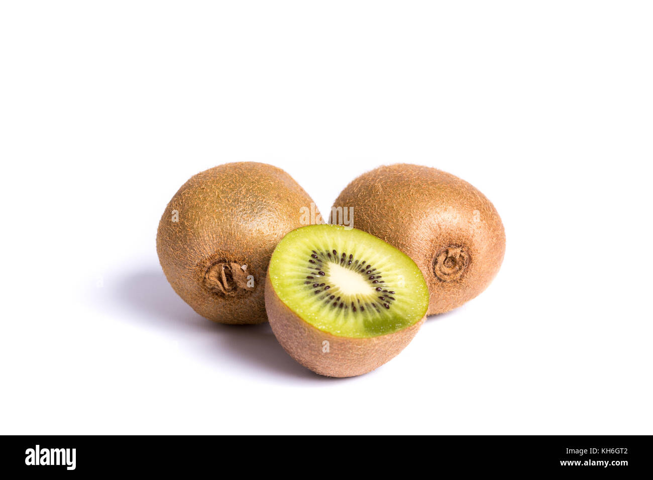 One whole kiwi and one kiwi cut in half isolated on white background ...